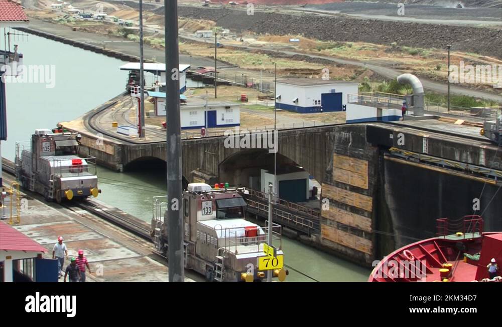 Locomotives pulling the ship through the chamber at Pedro Miguel Locks ...