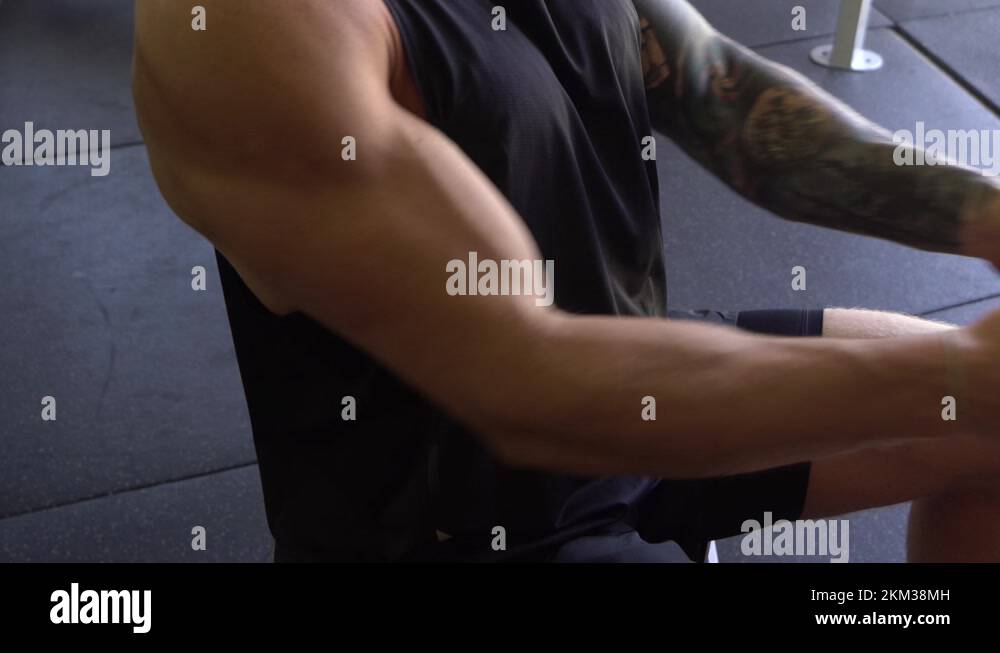 Muscly man in home gym exercising close grip cable lat row seated Stock ...