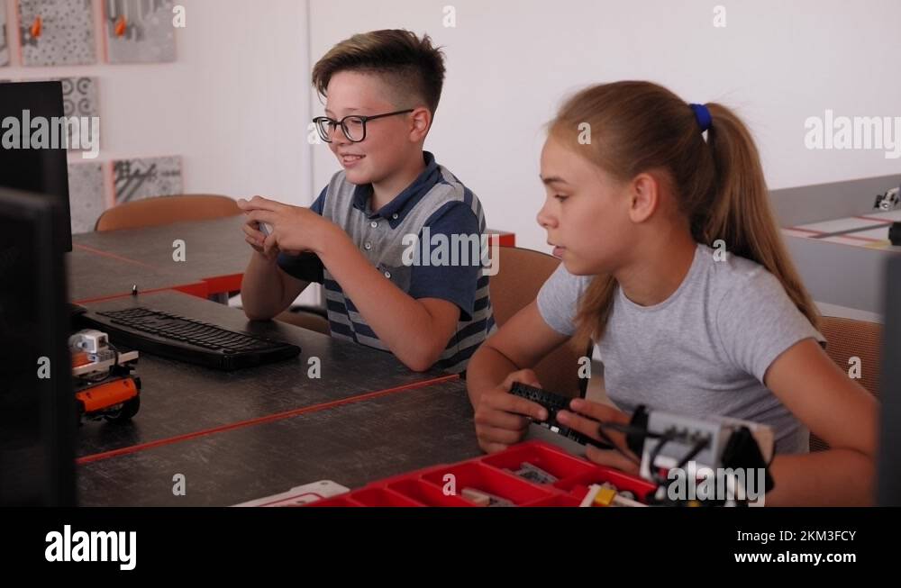 Kids building robot constructor from the plastics details at robotics ...