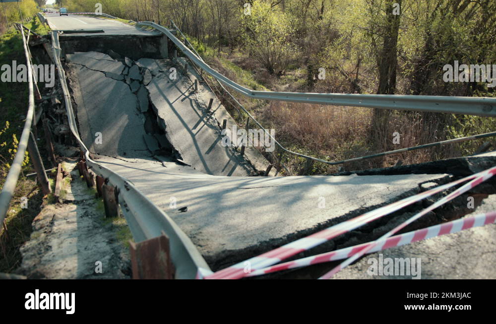 Flood damaged closed highway road, bridge. Cracked asphalt after ...