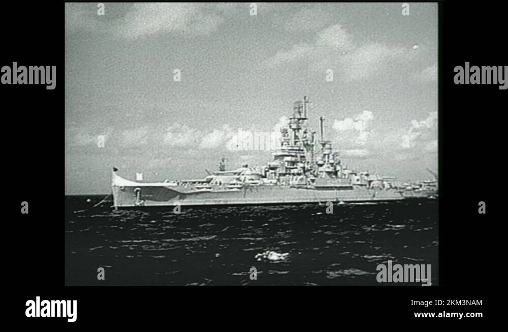 1940s: Navy ships anchored in harbor. Smoke rises from ship. Navy ships ...