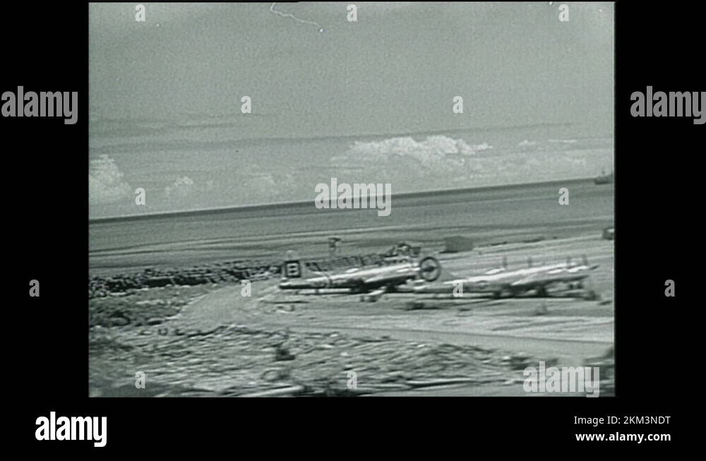 1940s: crescent-shaped island in Pacific, plane landing on air strip ...