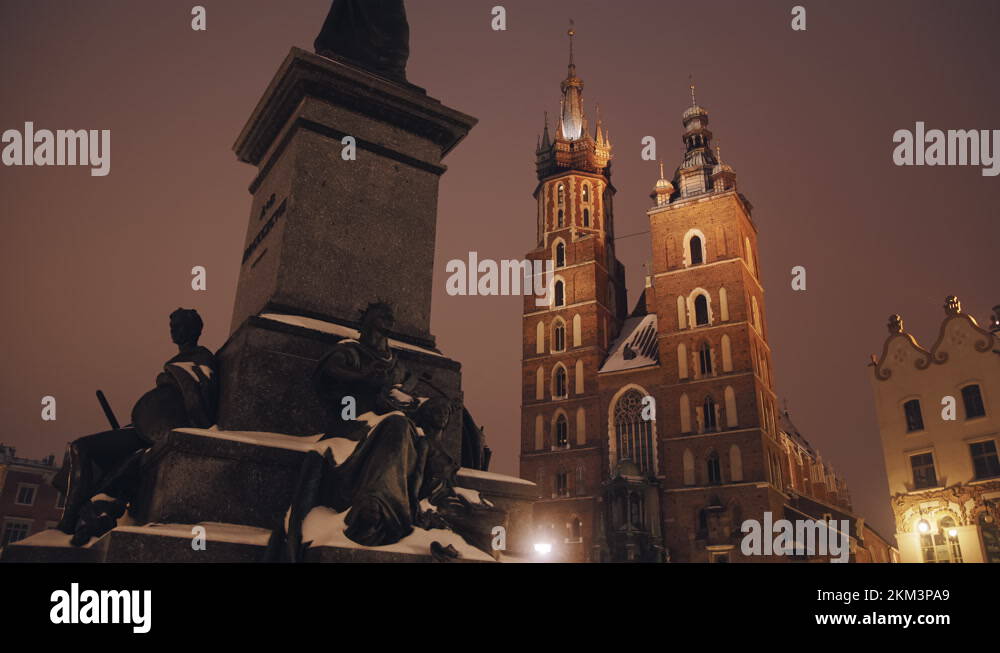 Close footage of Adam Mickiewicz Monument and St Mary Basilica Twin ...