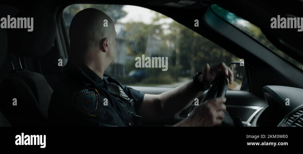 DX Caucasian police officer patrolling streets of neighborhood in ...