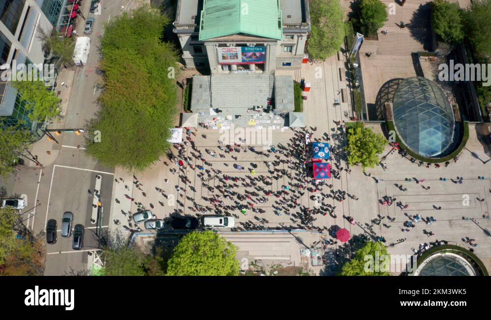A Crowd of people protest, static drone overhead shot in Downtown Stock ...