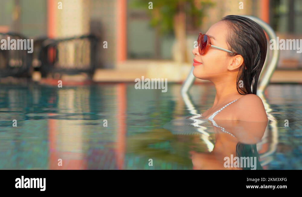 Young woman chilling inside hotel swimming pool face close-up on ...