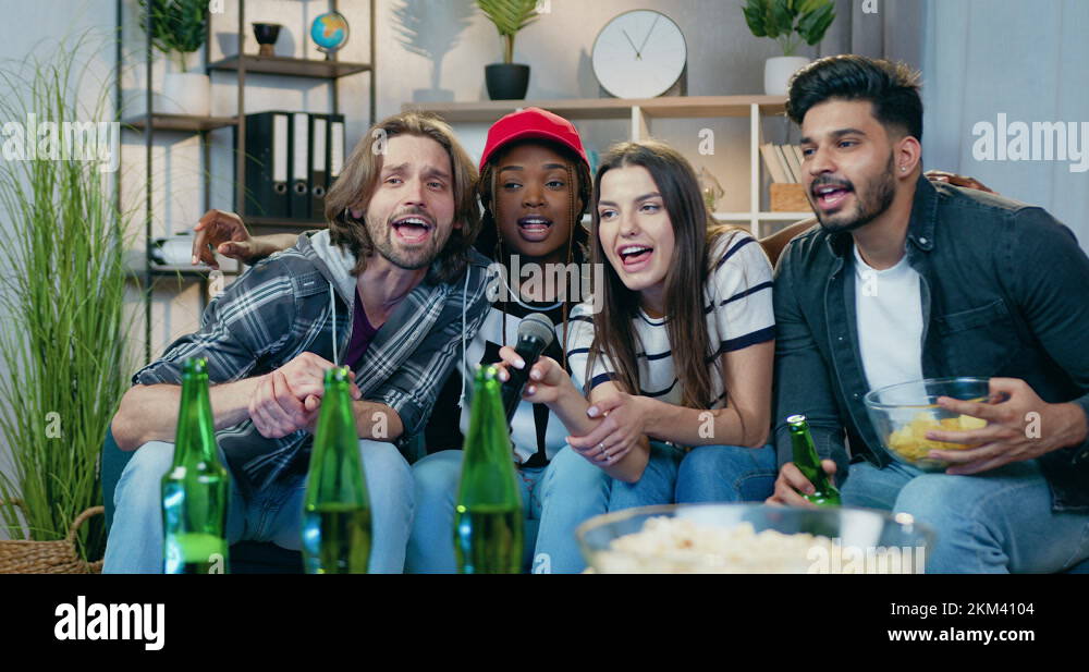 Lovely happy positive smiling young mixed races four friends singing ...
