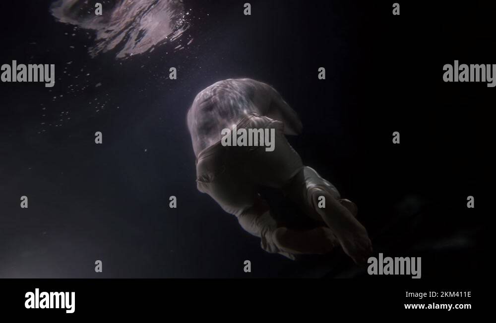 sunken man underwater, male figure is floating under water surface in ...