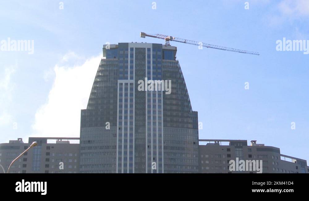 High-rise construction, the tower crane builds a skyscraper on a ...