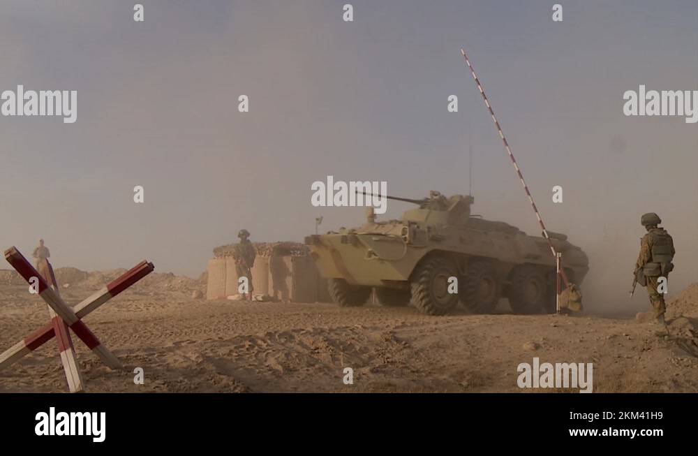 Military heavy armored vehicles leave a Russian checkpoint for a combat ...