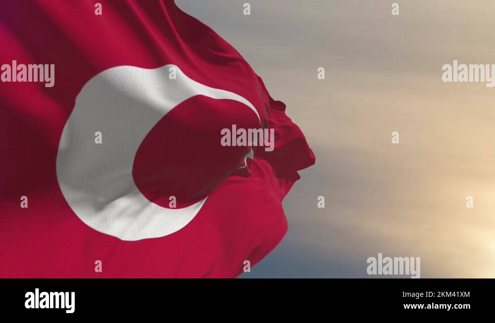 The Turkish flag flutters in the wind against the sunset sky, clouds ...
