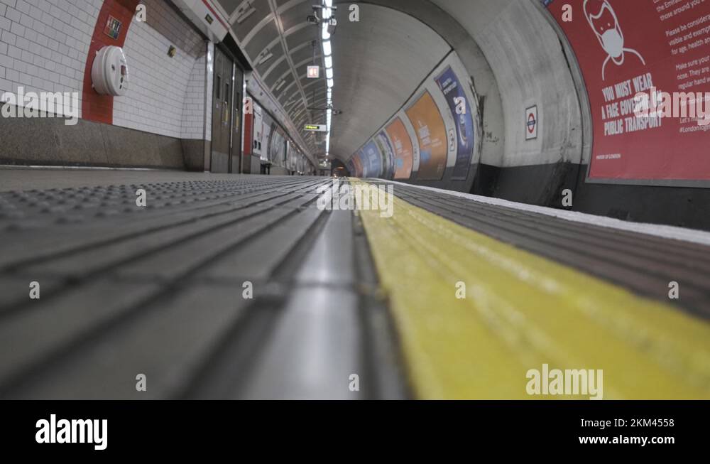 Central line london underground train arriving at an empty station low ...
