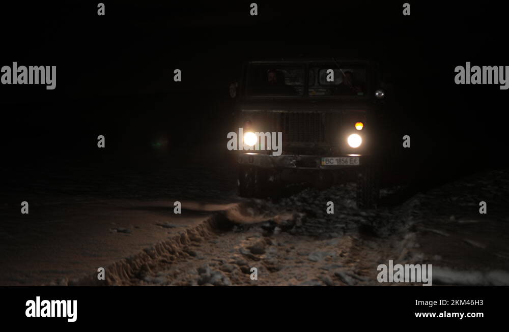 Night, low light, swamp, snow. Retro truck, old soviet military truck ...