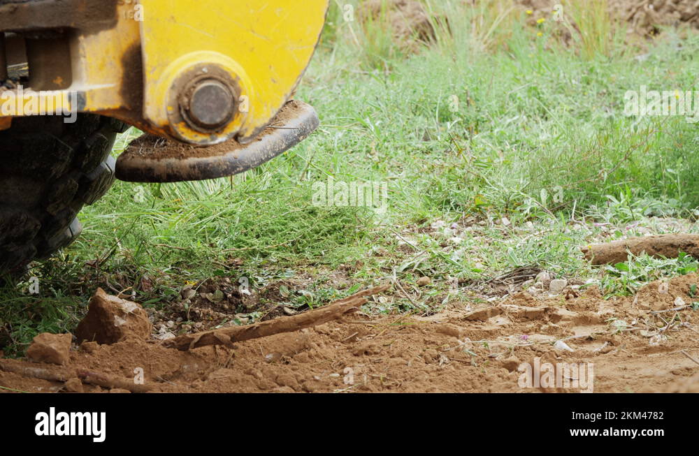 Backhoe operating in a Land on The Nature. Stabilizer Arm elevates ...
