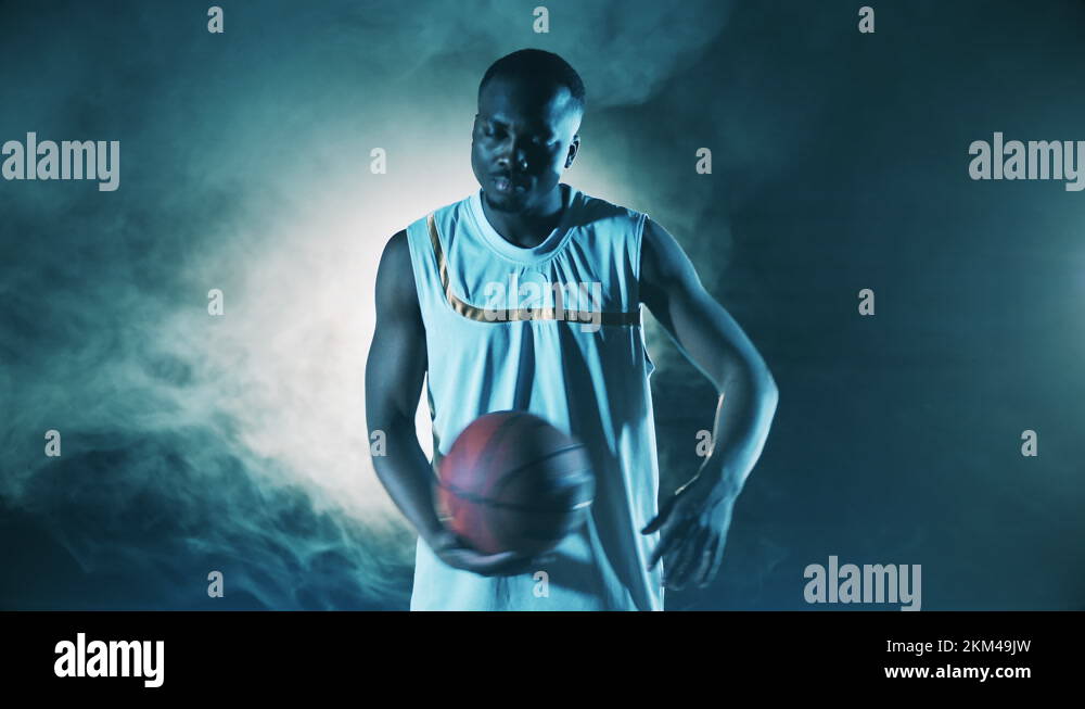Dark room with smoke and an african basketball player Stock Video ...