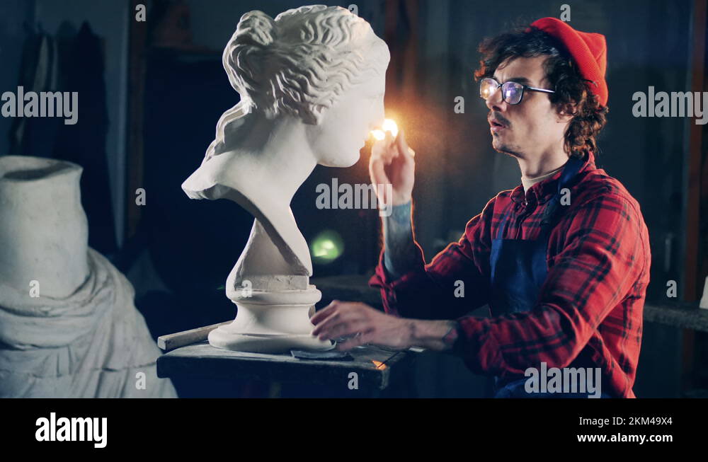 Sculptor is taking care of a gypsum bust. Inspiration, creative work ...
