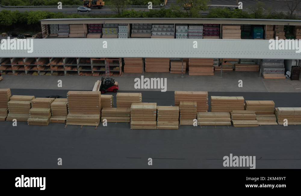 Pine, spruce, oak trees cut into boards. Forklift loads and moves ...