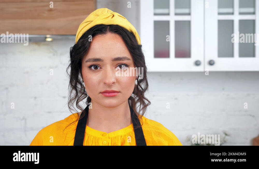 Close up sad beautiful housewife looking at camera in home modern ...