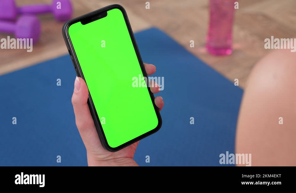 Green screen smartphone: Close up smartphone in hand looks green ...