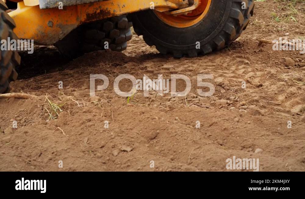 Excavator working. Backhoe operating in a Land. Wheels close up Stock ...