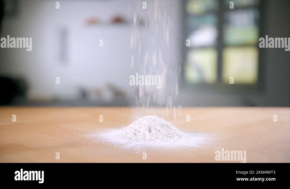 Falling of wheat flour on a kitchen counter against a blurred kitchen background Stock Video ...