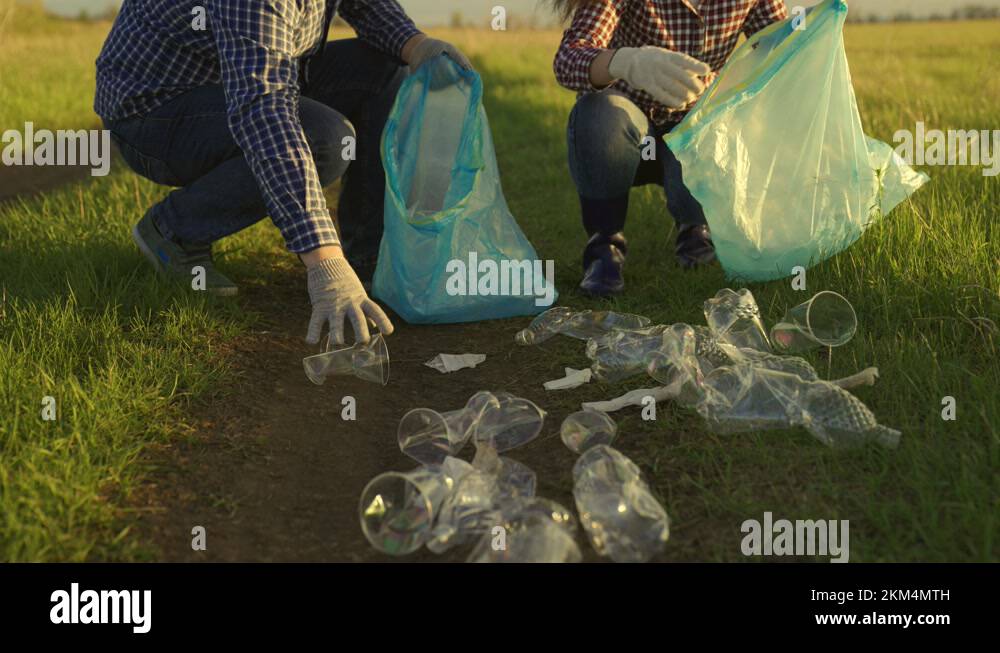 Volunteers clean up trash. People are engaged in cleaning plastic ...