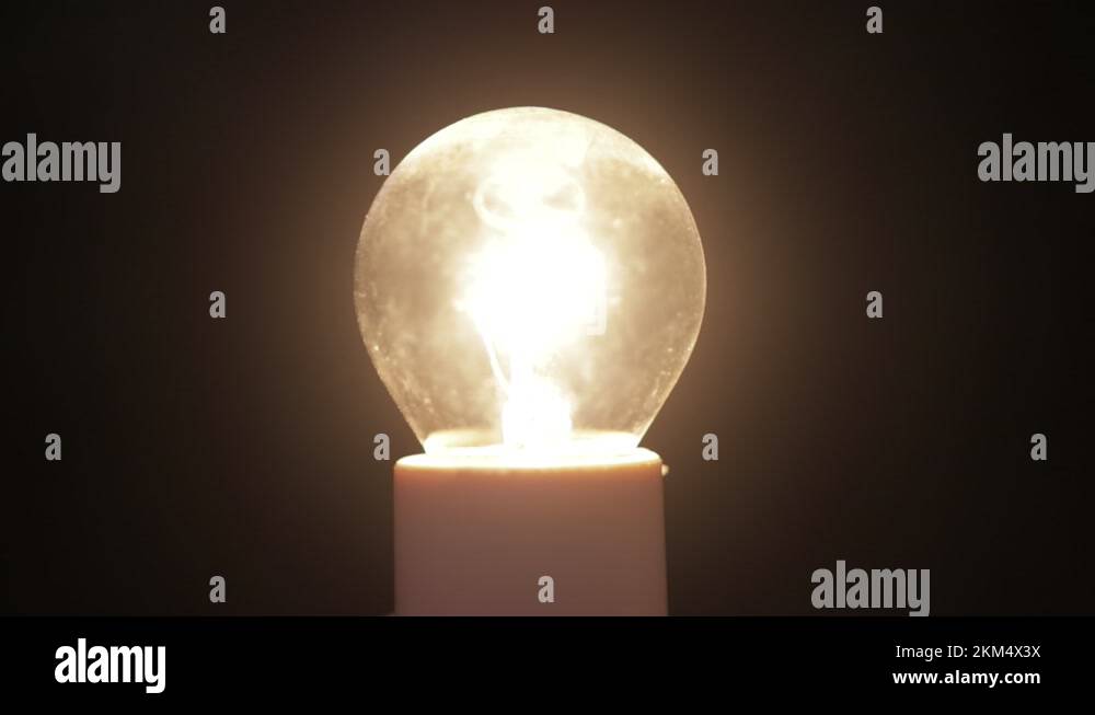 Static Shot of Incandescent Light Bulb Shining in the Dark Background ...
