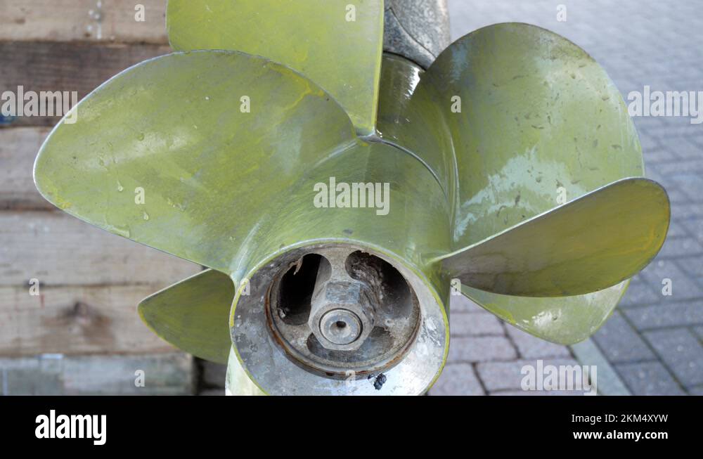 Yellow metal yacht boat propeller rotor blades under maintenance vessel ...