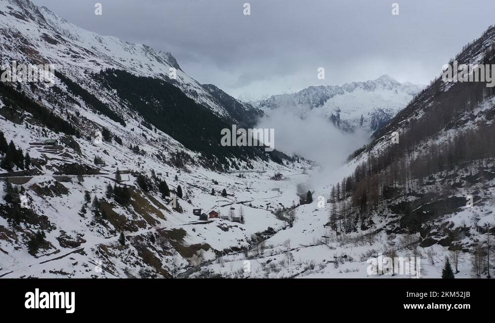 Flight over snow-capped mountains in the Swiss Alps on a winter's day ...