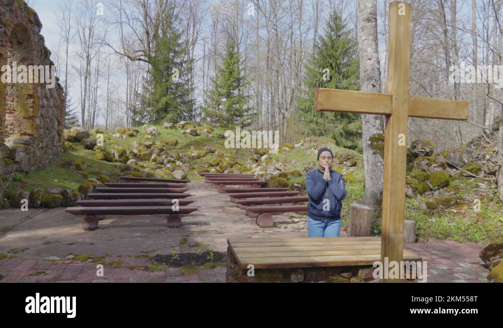 Woman praying in outdoor church Stock Video Footage - Alamy