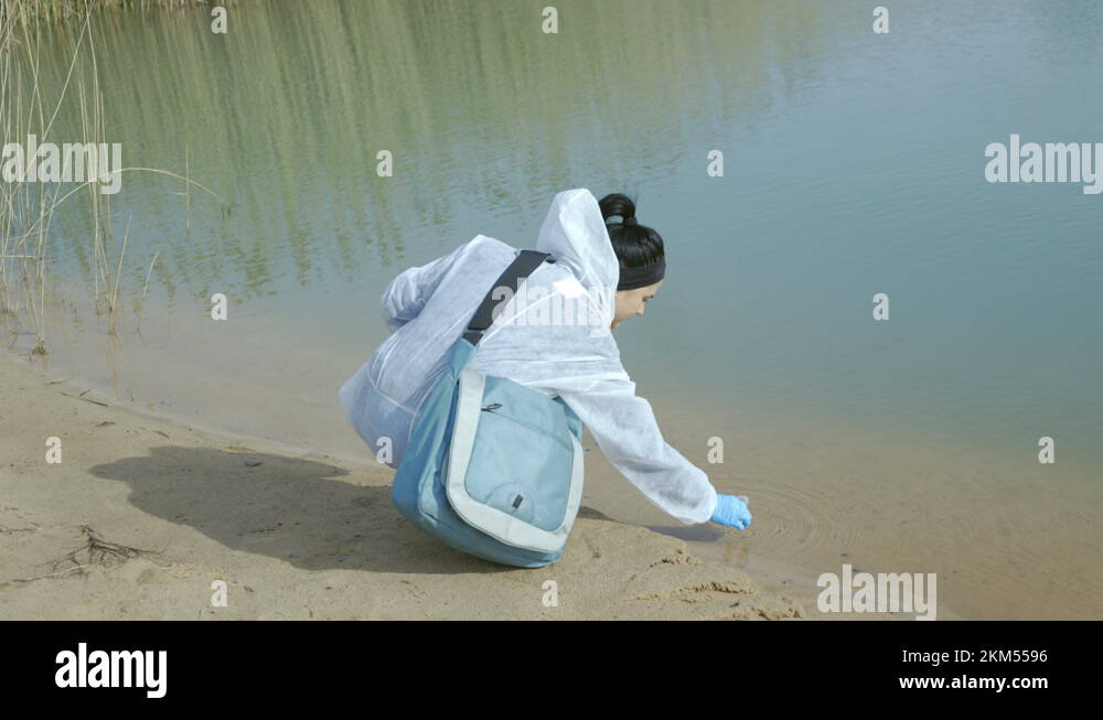 Scientist ecologist taking a water sample in the polluted lake Stock ...