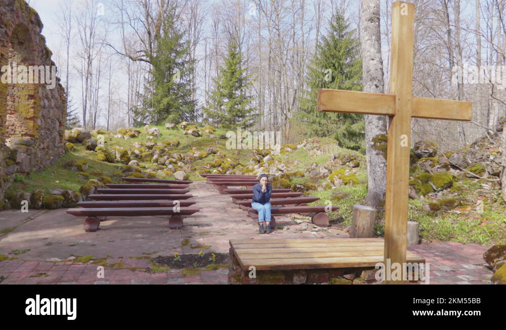 Woman sitting on bench in outdoor church and praying Stock Video ...