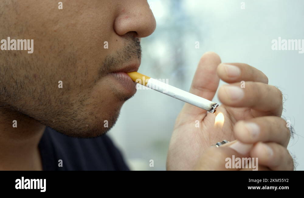 Young men smoking He smoked and spat out a lot of smoke. It is ...
