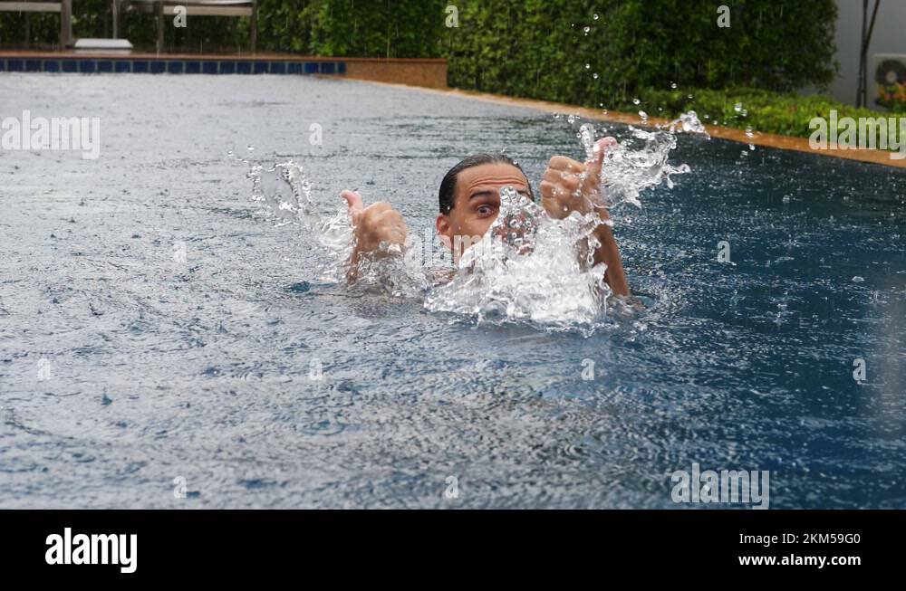 Funny guy turn head to camera and show thumbs up from under water with ...