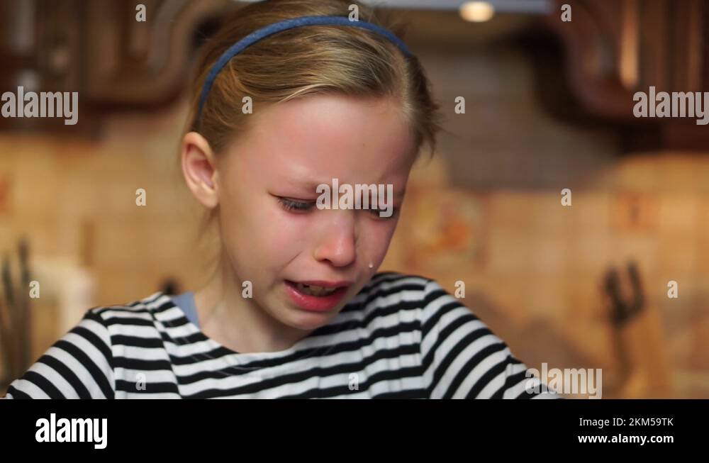 Blond child girl crying heavily tears drop down her face offended in ...