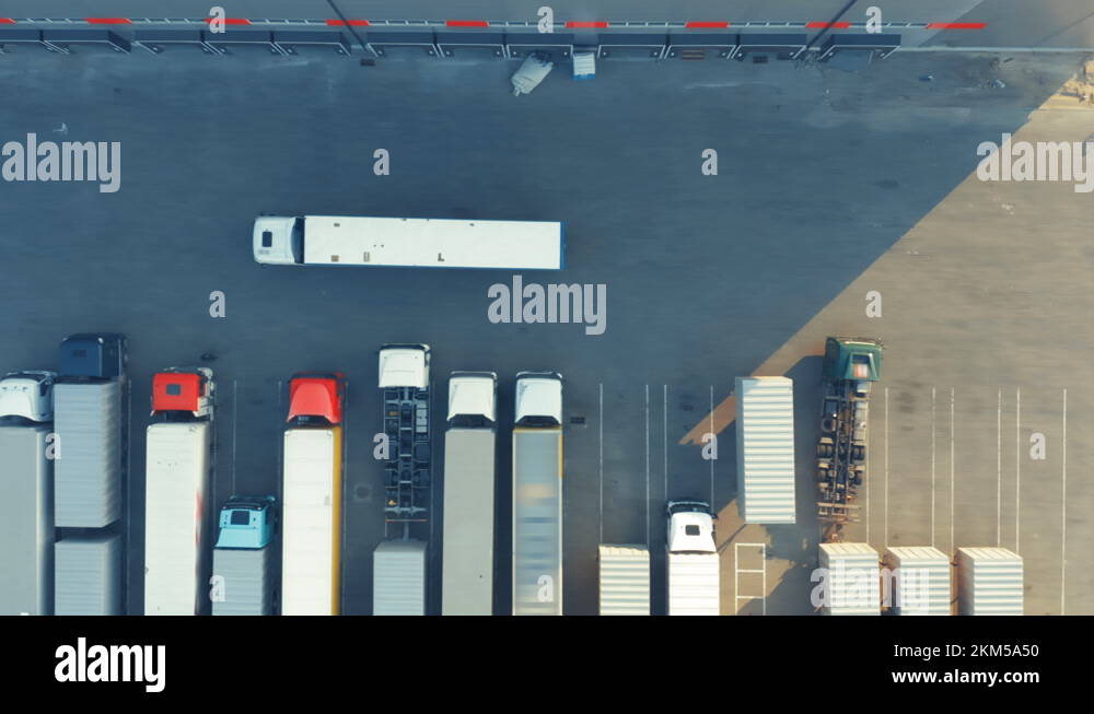 Semi-trailer truck is travelling along a warehouse in a logistics park ...