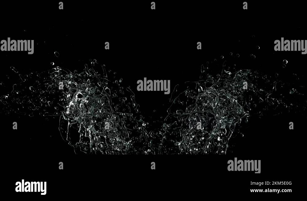 Slow motion splash of water and flying drops around on a black ...