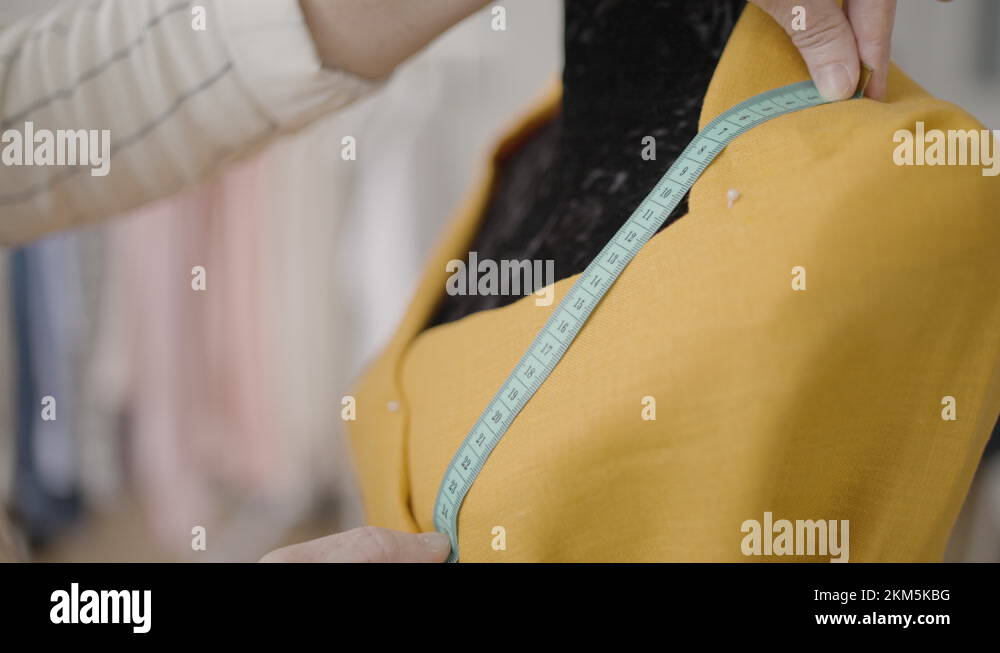 Woman taking measurements for sewing, using tape, stages of dressmaking ...