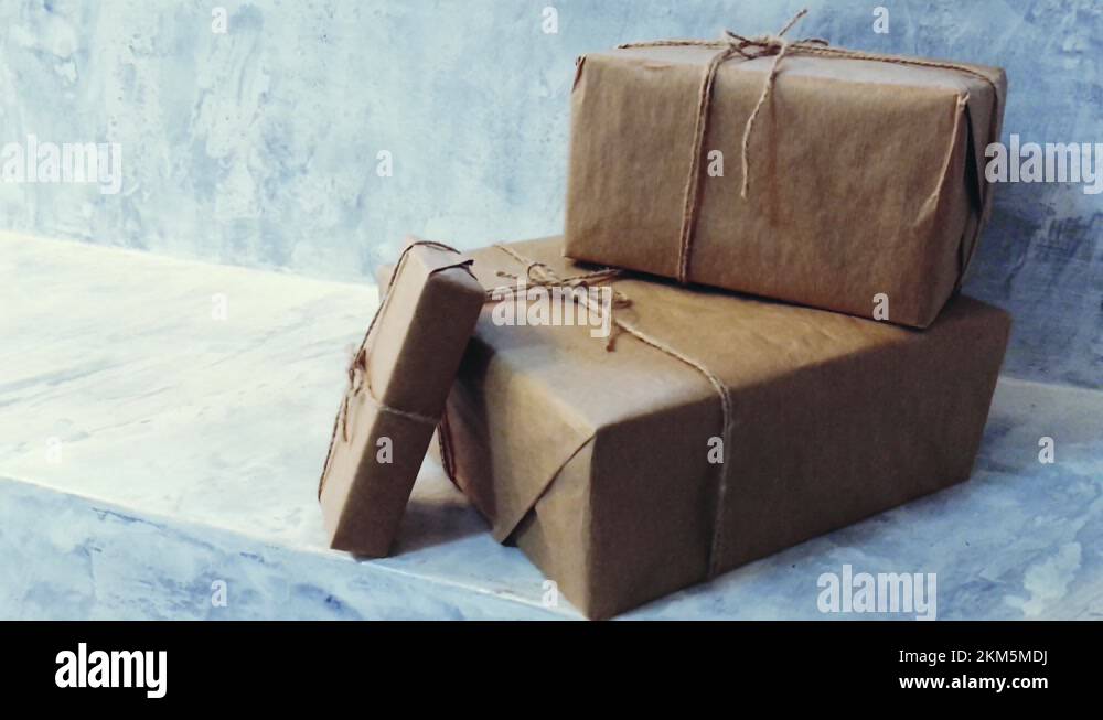 Packaged boxes for postal delivery service, parcels wrapped in brown ...