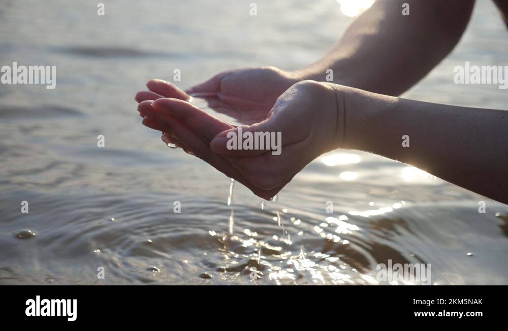 Close up of Hands in cupped form getting water from a lake Stock Video ...