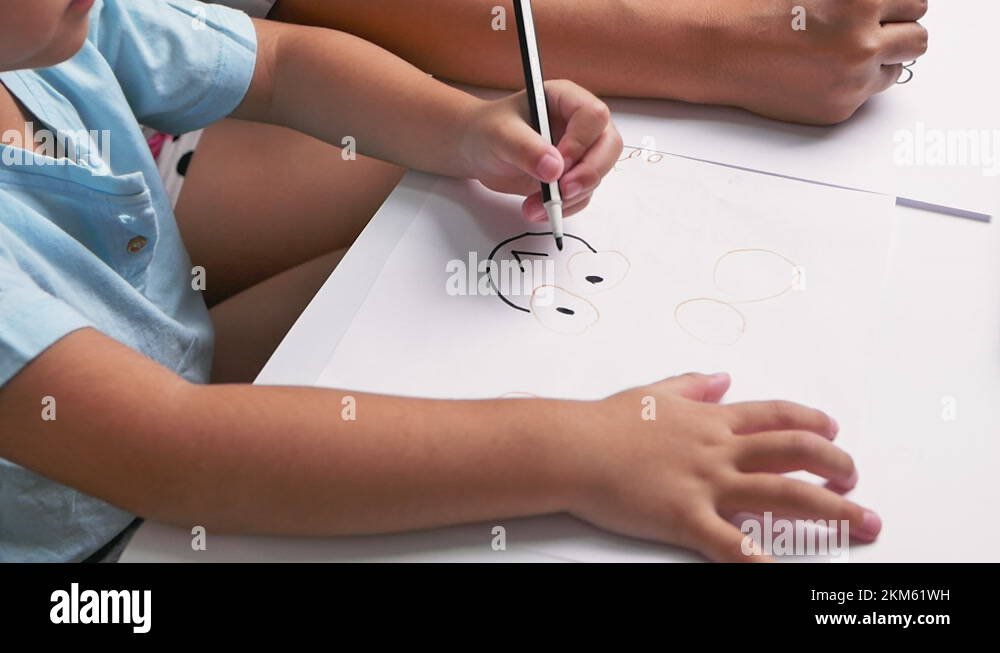 Little girl deliberately learning to draw through the laptop computer ...