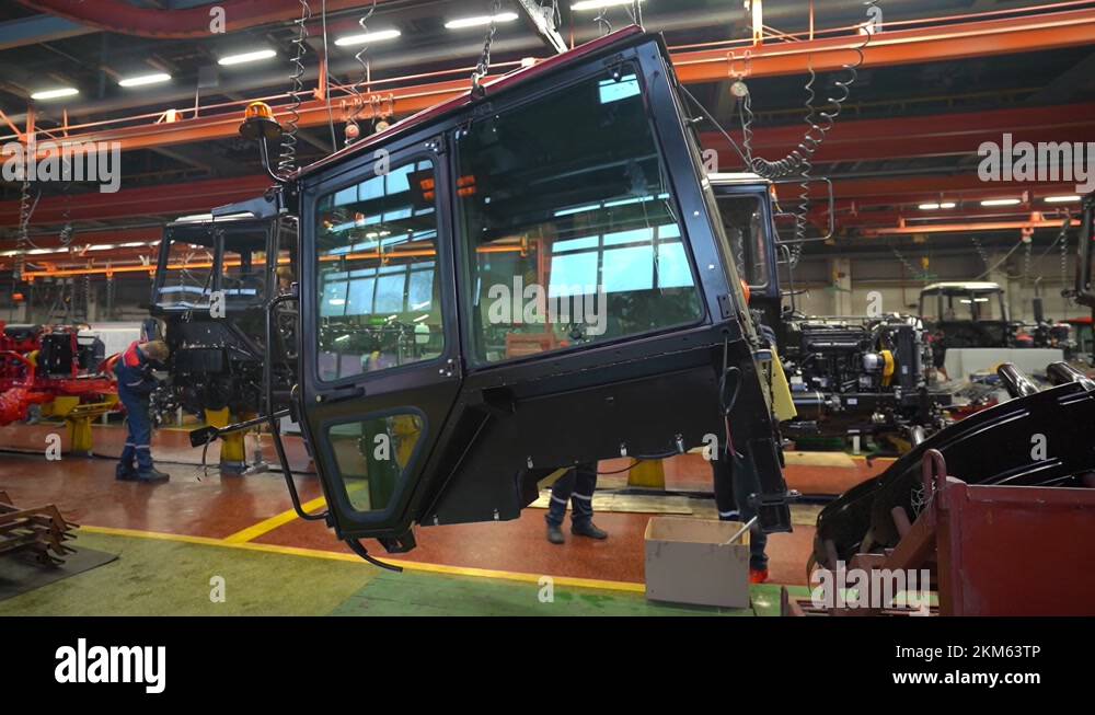 Assembly shop of heavy tractors, equipment is on the conveyor, the ...