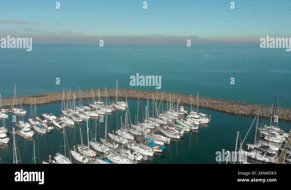 Yachts moored at marina behind sea wall, Port Phillip Bay, Melbourne ...