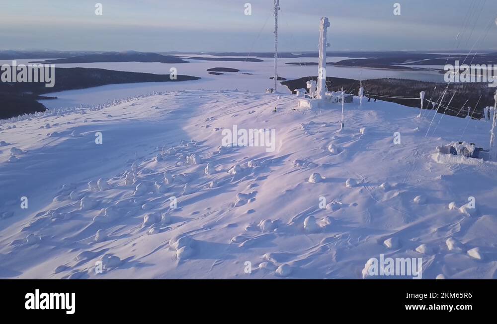 Icy cellular base station antenna covered with snow. Cell site tower on ...