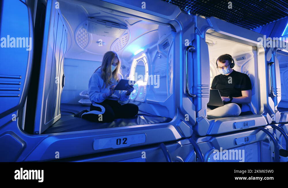 Adjoined rooms of a capsule hotel with a guy and a girl in them Stock ...
