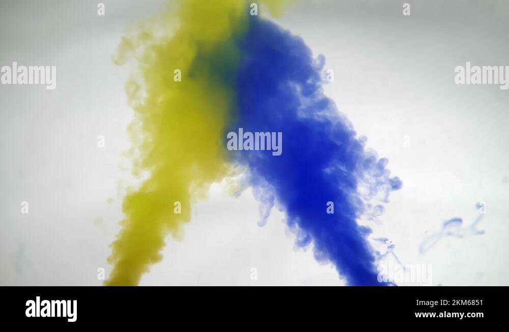 Mixing yellow and blue paint colors in water. Colo Stock Video Footage ...