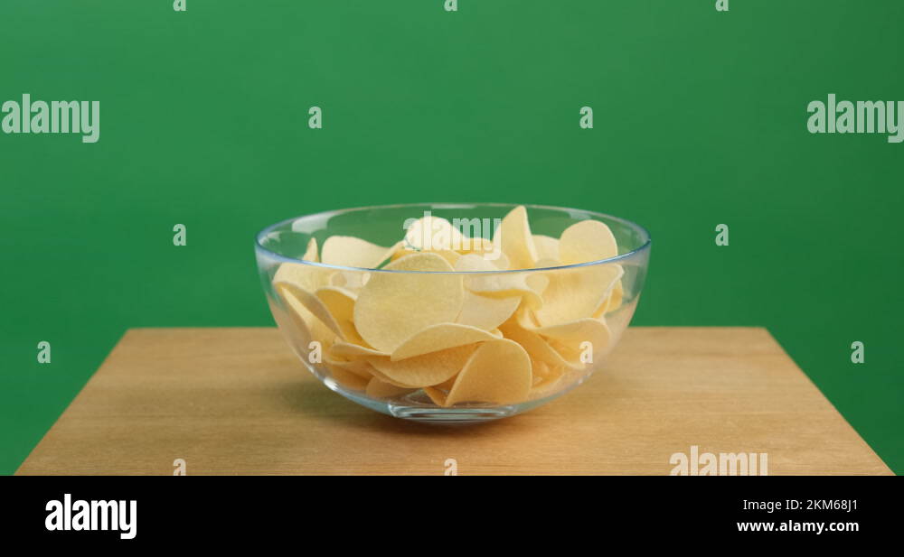 Chips fill a plate, green screen Stock Video Footage - Alamy
