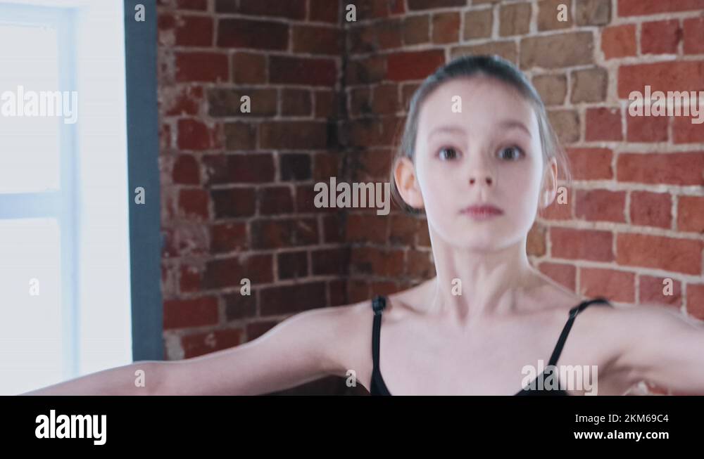 Ballet dancing indoors - a little gymnastics girl dancing in black suit ...