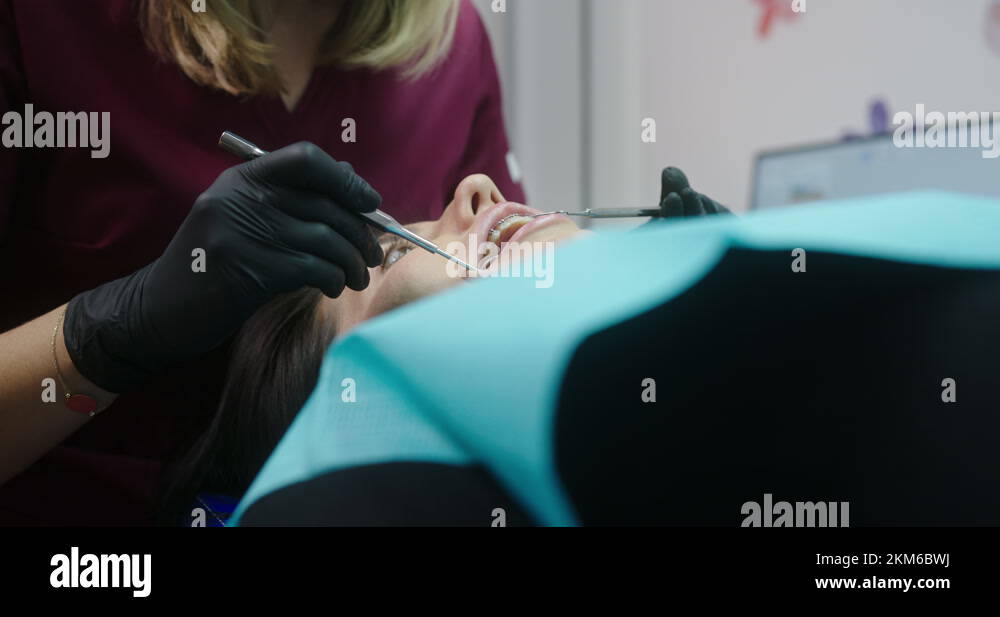 Dental treatment process examination of braces female patient lying ...