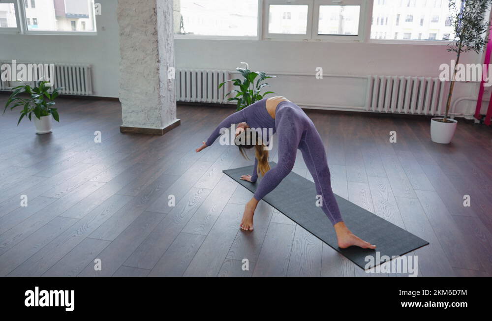 Yogi woman balancing in Camatkarasana and Patita Tarasana poses Stock ...